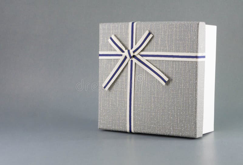 Grey Gift Box with Ribbon on Green Grass with Sun Light in the Morning ...