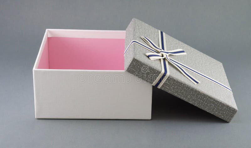 Grey Gift Box with Ribbon on Green Grass with Sun Light in the Morning ...
