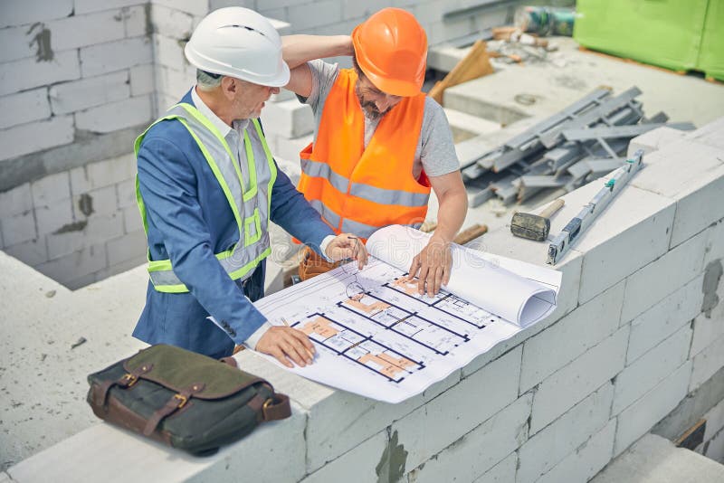 Civil Engineer Looking at a Puzzled Male Worker Stock Image - Image of ...