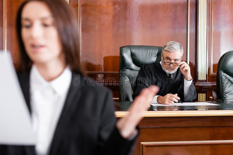 Grey-haired Judge Adjusting Eyeglasses while Stock Image - Image of ...