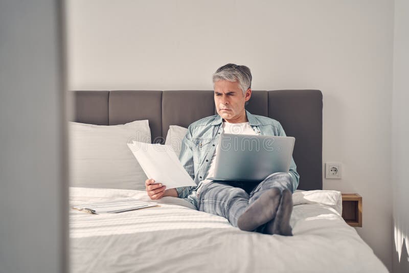 Caucasian Male Looking at Papers and Checking Stock Photo - Image of ...