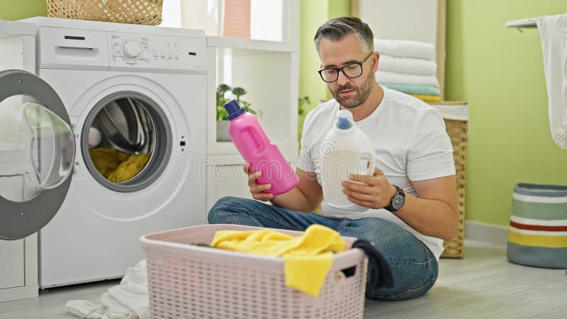 Grey-haired Man Washing Clothes Choosing Detergent Bottles at Laundry ...
