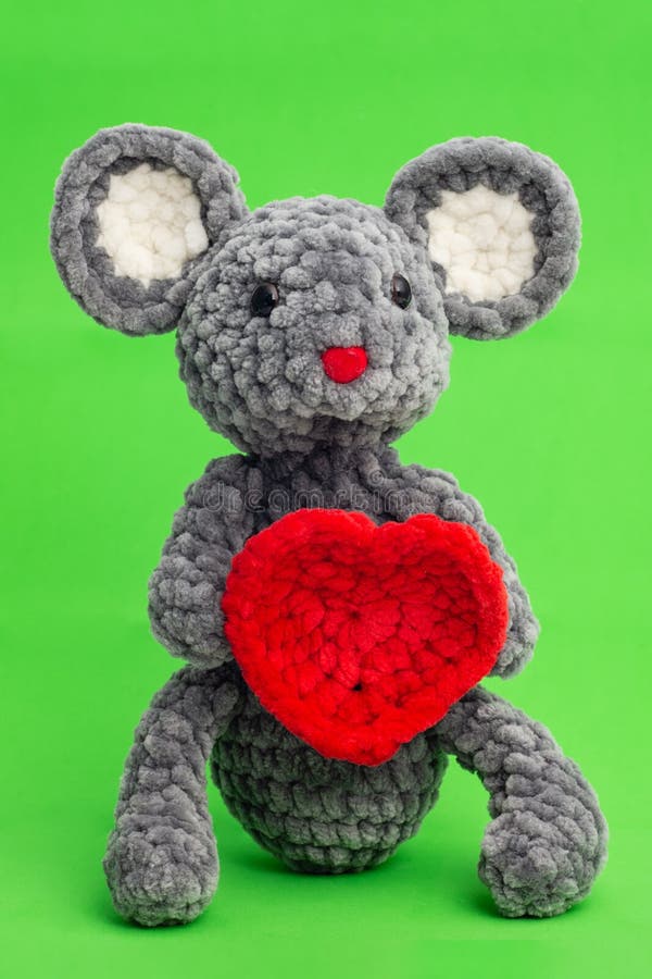 Grey Knitted Mouse with a Heart in Hand on a Green Background Stock ...