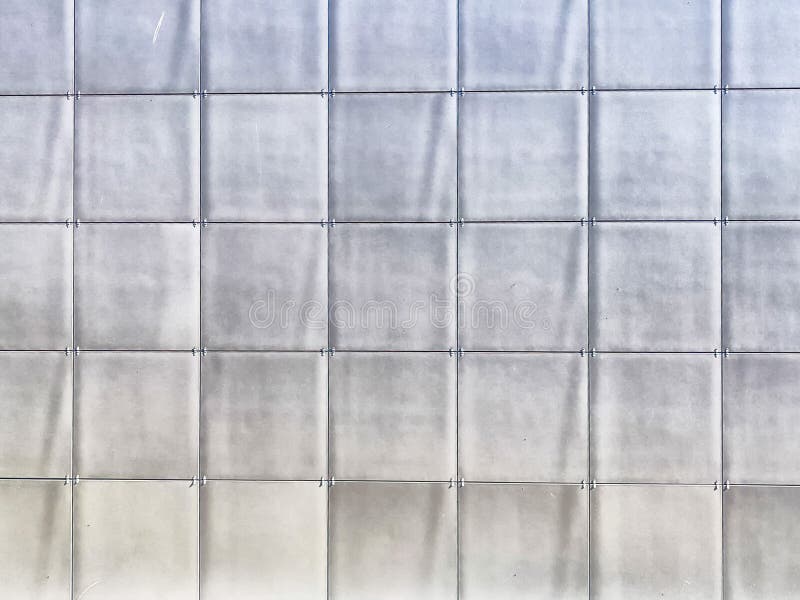 A Grey Metal Wall with Square Panels, Each Panel Held in Place by Small ...