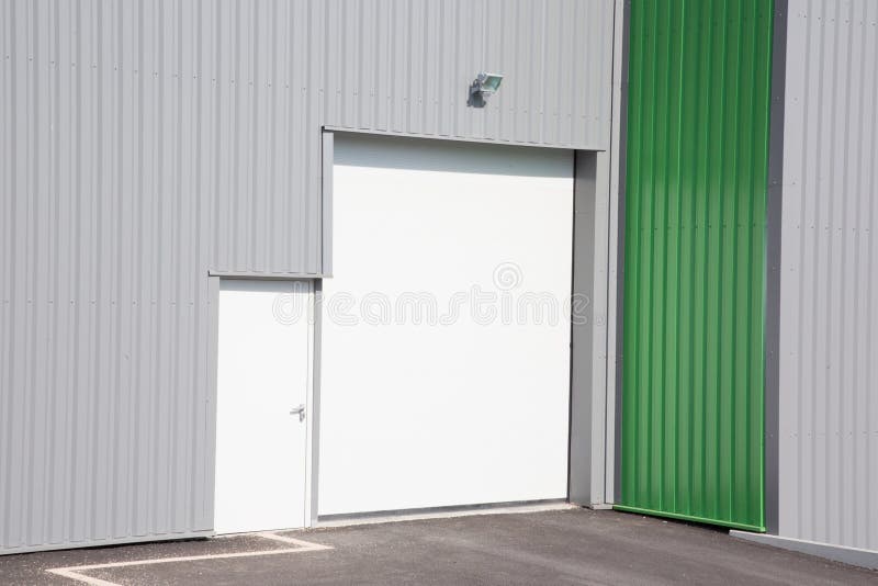 Grey Modern Industrial Unit with Roller Doors Stock Photo - Image of ...