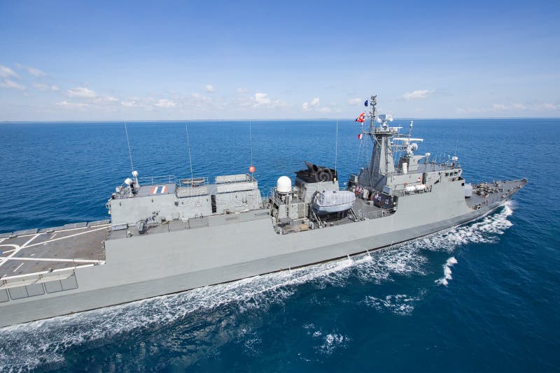 Modern Warship in the Bay with Sailing Ship in Background Stock Photo ...