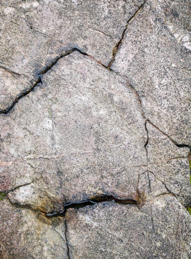 Grey rock with some cracks stock photo. Image of construction - 192030376