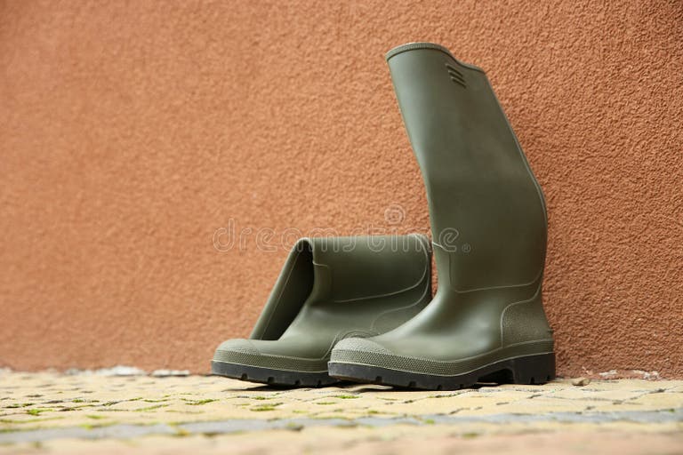 Grey Rubber Boots on Pavement Near Wall Outdoors Stock Photo - Image of ...