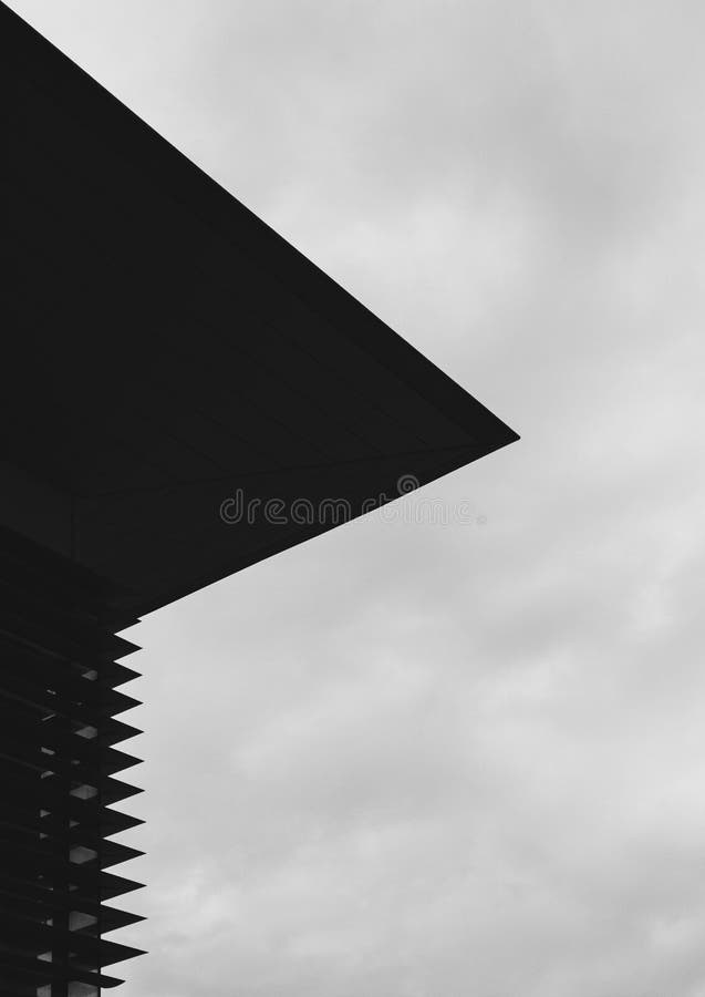 Grey-scale Shot of the Roof of a Modern Building with the Sky in the ...