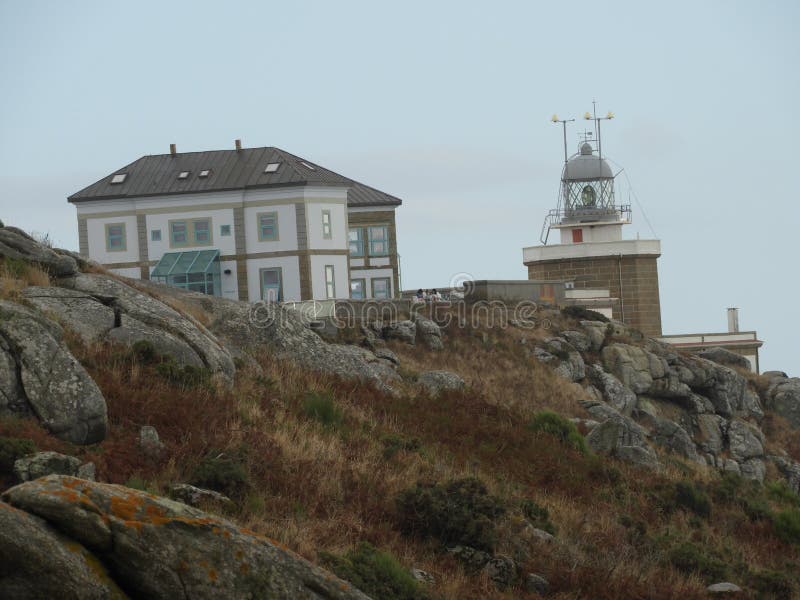 Grey Scenery of a Big House Near a Lighthouse on a Rocky Slope Stock ...