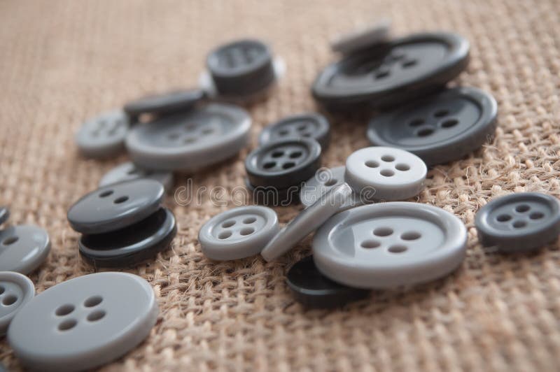 Grey Sewing Buttons on Hessian Texture Background Stock Image - Image ...