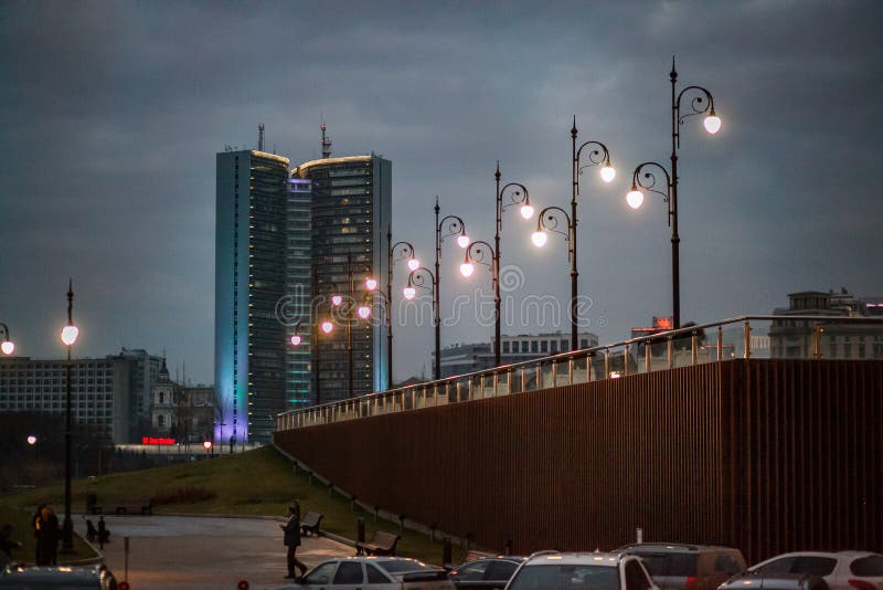 Grey Soviet Constructivist Building with Evening Illumination and Stret ...