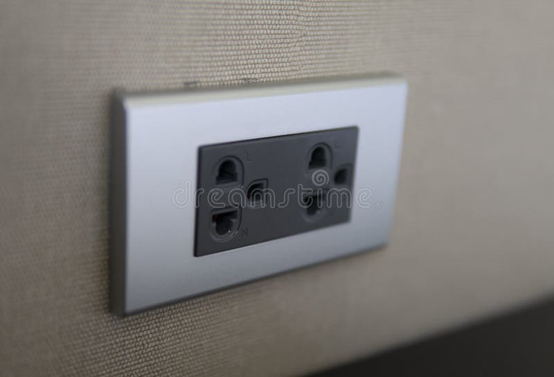 Grey Universal Electricity Sockets Plug on a Yellow Wall. Stock Image ...