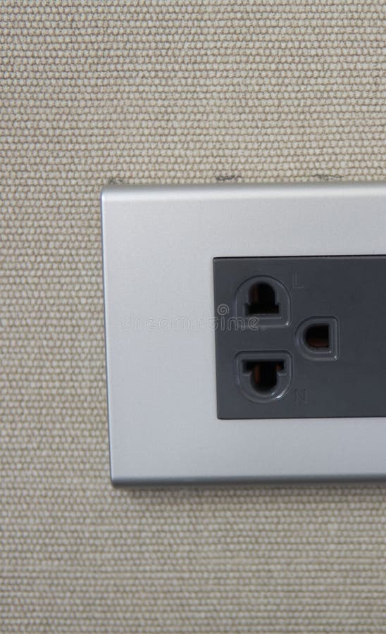 Grey Universal Electricity Sockets Plug on a Yellow Wall. Stock Image ...