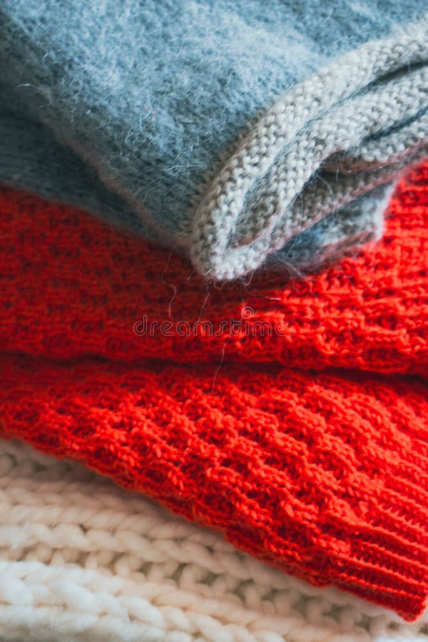 Grey, White and Bright Orange Knitted Sweaters in a Pile. Stack of Cozy ...