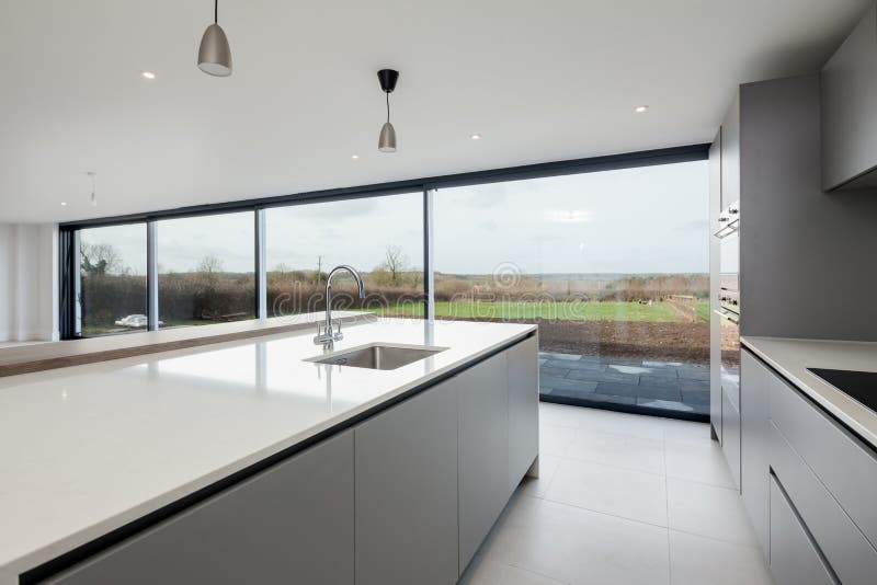 Grey and White Open Plan Kitchen with Granite Countertop Editorial ...