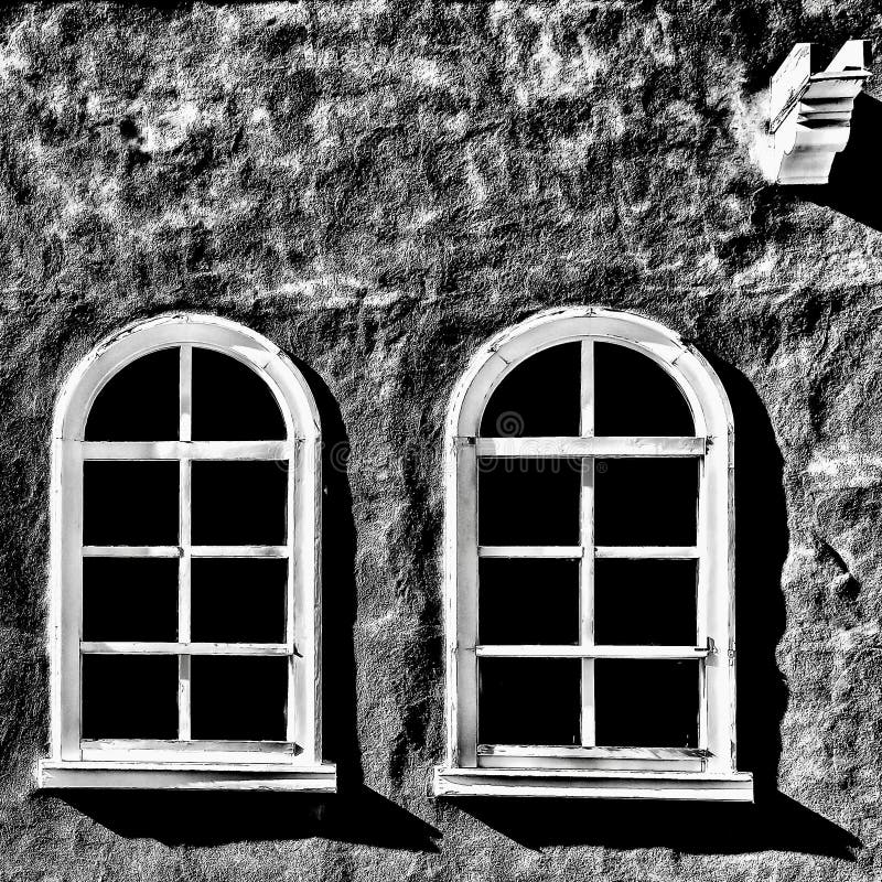 Greyscale Closeup of White Windows on an Old Wall Under the Sunlight at ...