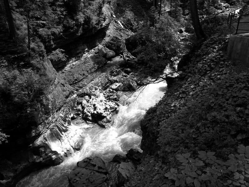 Greyscale High Angle Shot of a River Flowing among the Rocks and Cliffs ...