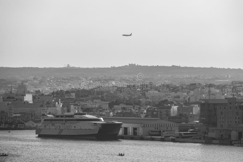 Greyscale of a Port with Numerous Building on the Background and a Big ...