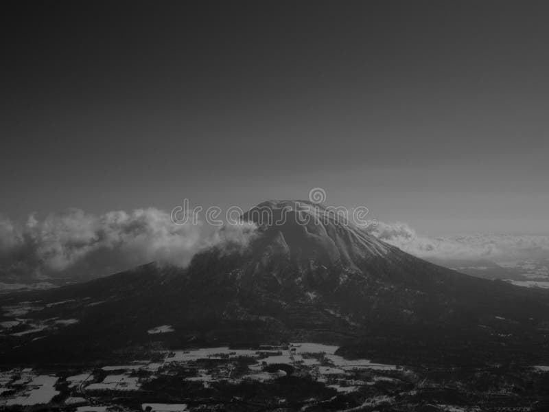Greyscale Scenery of a Mountain Blending in with the Fluffy Clouds ...