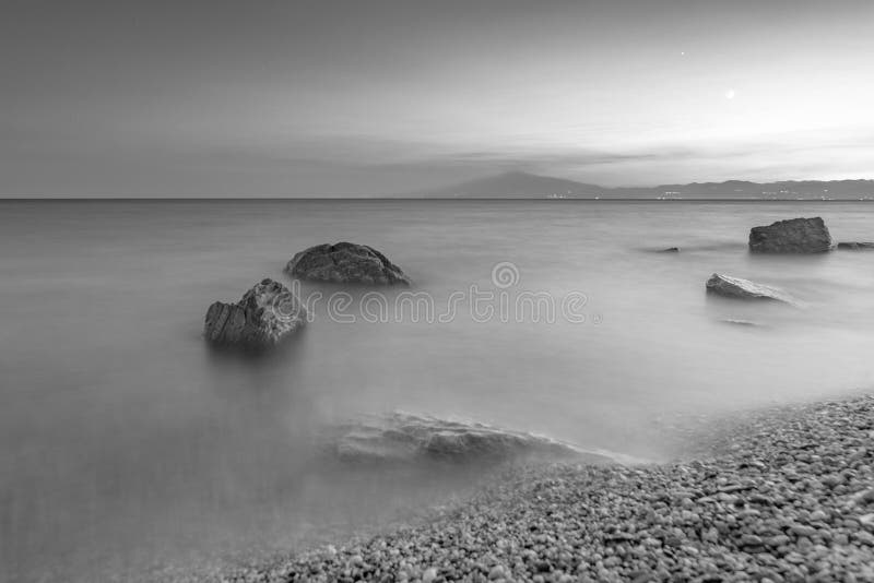 Greyscale Seascape at Sunset with Rock Formations in the Water Stock ...
