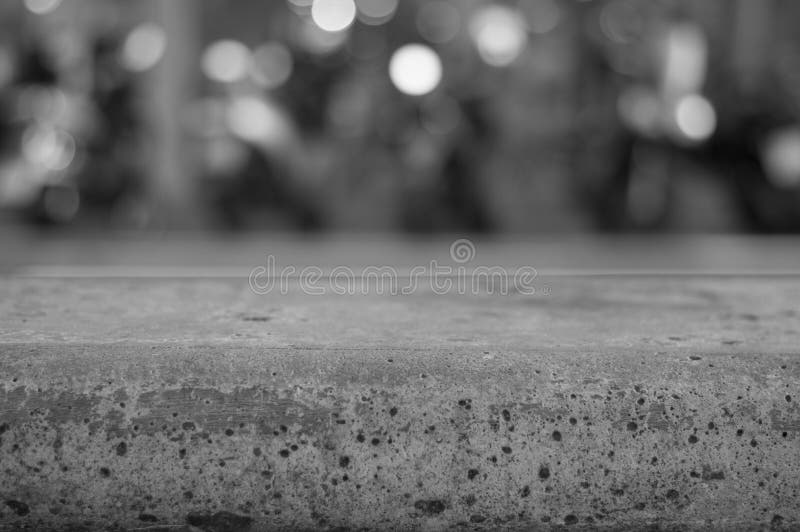 Greyscale Shot of a Cement Surface with Blurred Lights in the ...