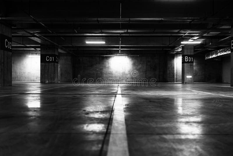 Greyscale Shot of an Empty Underground Parking Lot Stock Photo - Image ...