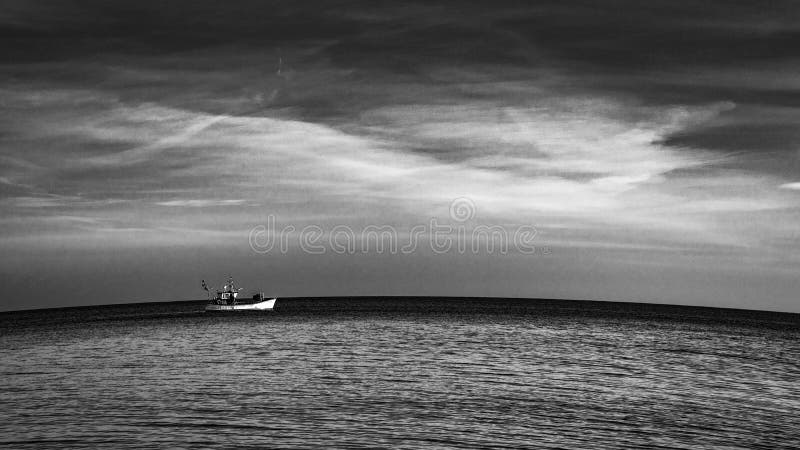 Greyscale Shot of a Ship in the Ocean Under the Crazy Cloudy Sky Stock ...