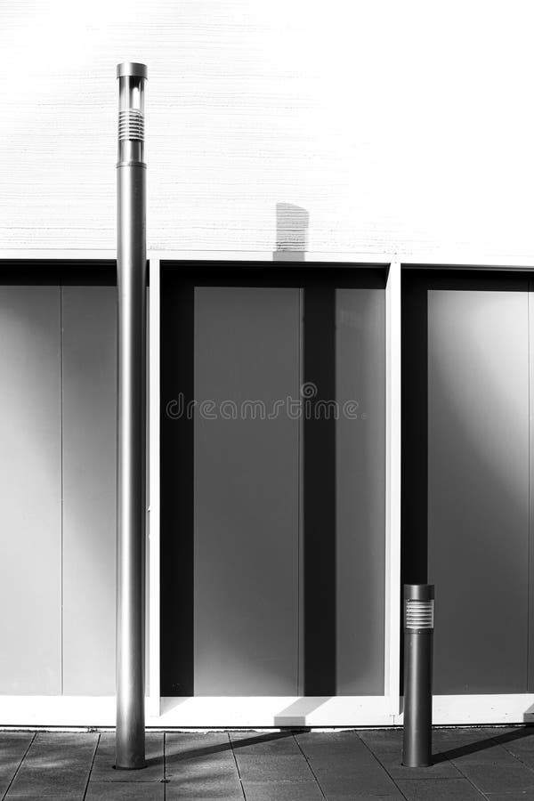 Greyscale Vertical Shot of Poles in a Modern Building Stock Image ...