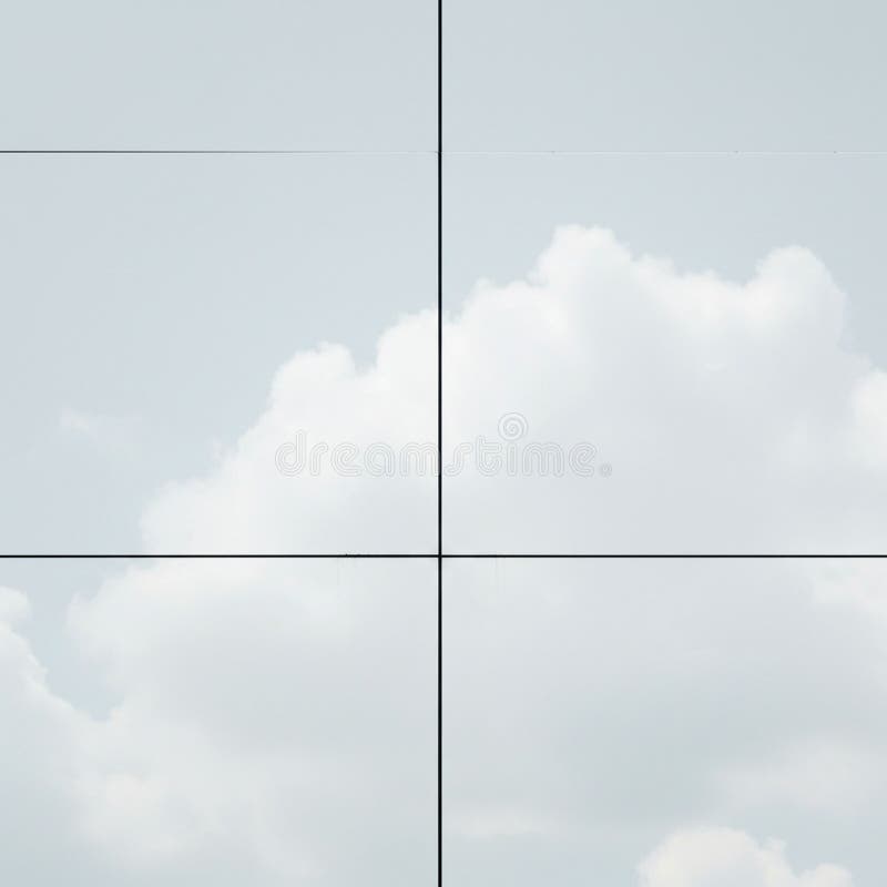 A Grid of Reflective Glass Panels Forms a Window View of a Soft Cloud ...