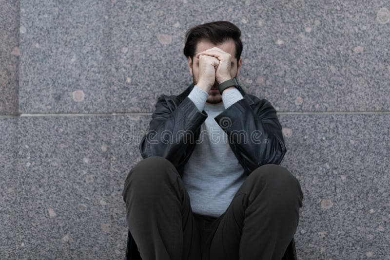 Grieving Man Sitting Upset Covering His Face with His Hands Stock Photo ...