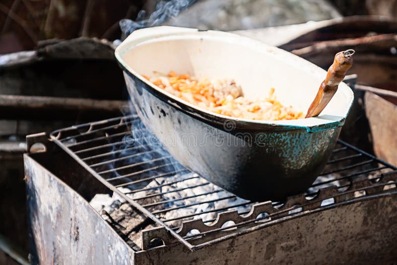 On the Grill Stands a Cauldron in Which To Prepare Meat and Vegetables ...