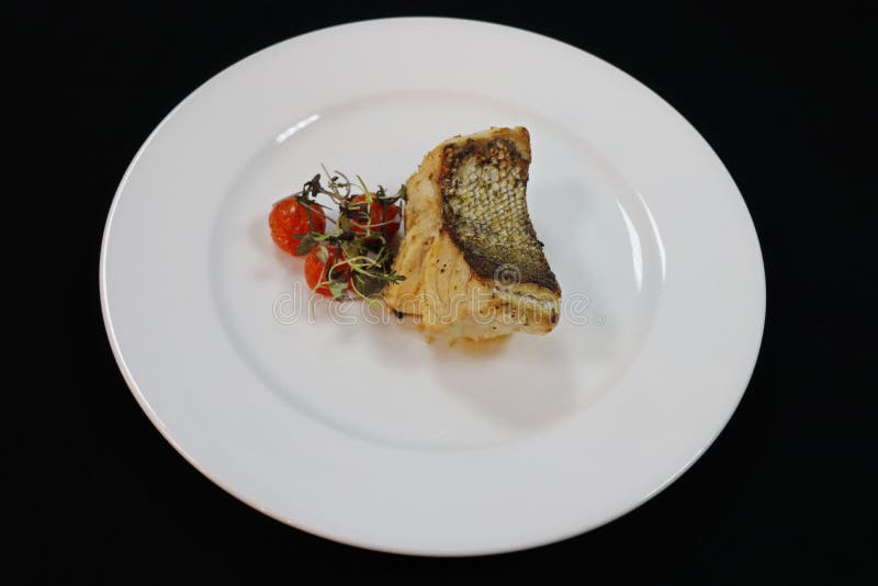 Grilled Atlantic Cod Fish Fillet on a White Plate with Cherry Tomato ...