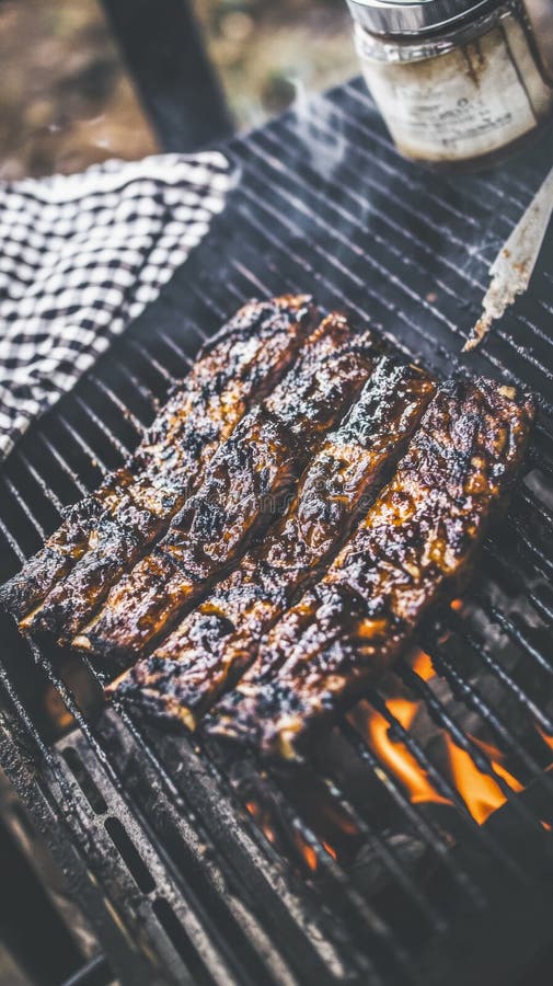 Grilled Barbecue Ribs Sizzling on Open Flame with Glossy Marinade Stock ...