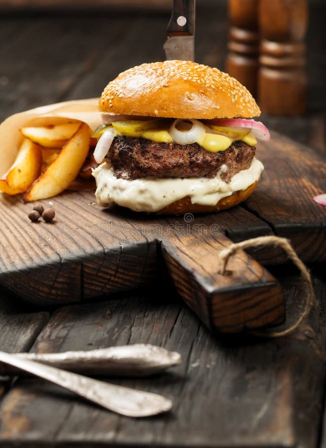 Grilled Beef Burger with Potatoes on Rustic Wooden Table Stock Image ...