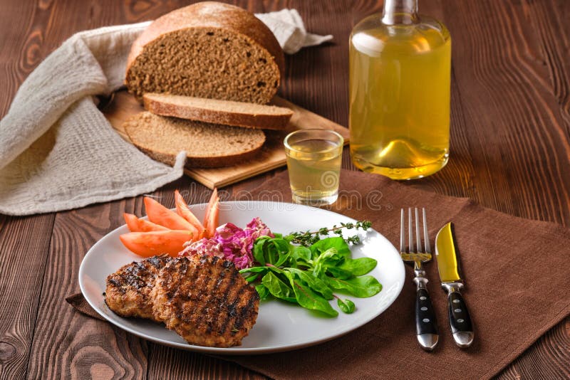 Grilled Beef Cutlet with Fresh Salad, Brown Bread and Moonshine on ...