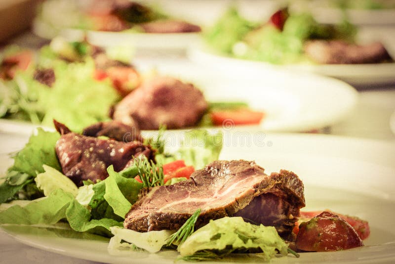 Grilled Beef with Fresh Salad Mix and Tomatoes Served on White P Stock ...