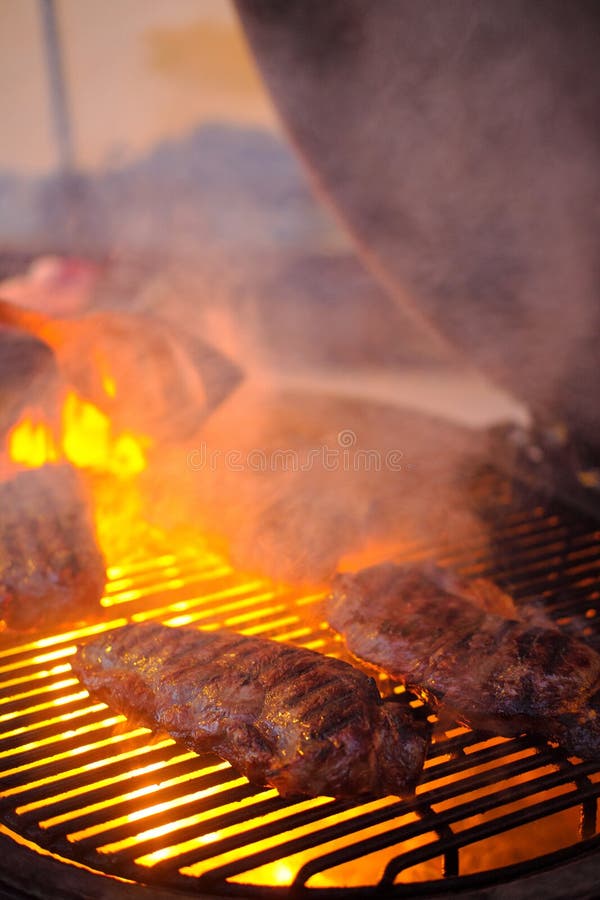Delicious Grilled Beef Steak with Fire on Background Stock Photo ...