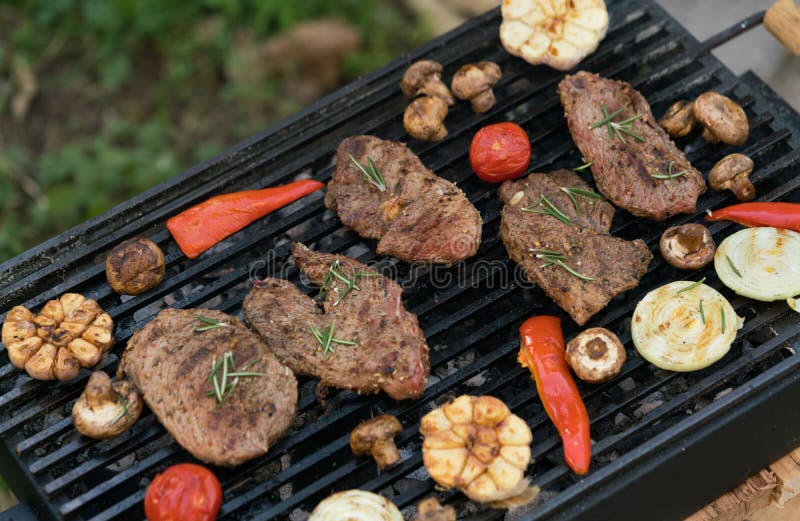 Grilled Beef Steak on the Grill with Vegetables Close-up. Stock Image ...