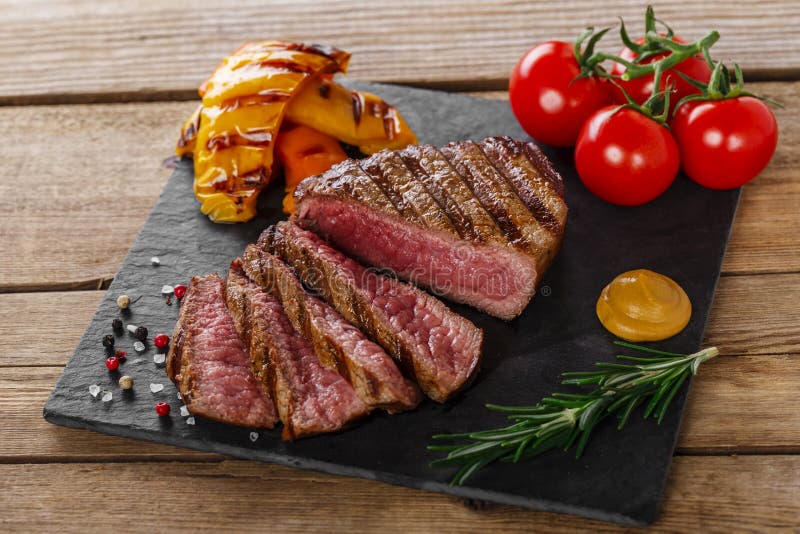 Grilled Rare Beef Steak Served on Wooden Board with Fried Potatoes ...