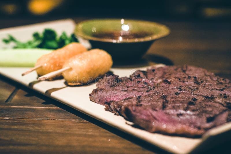 Grilled Beef Steak with Grilled Rice Cake on a Stick Stock Image ...