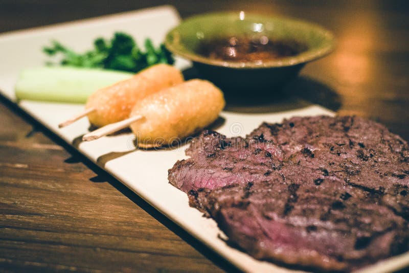 Grilled Beef Steak with Grilled Rice Cake on a Stick Stock Photo ...