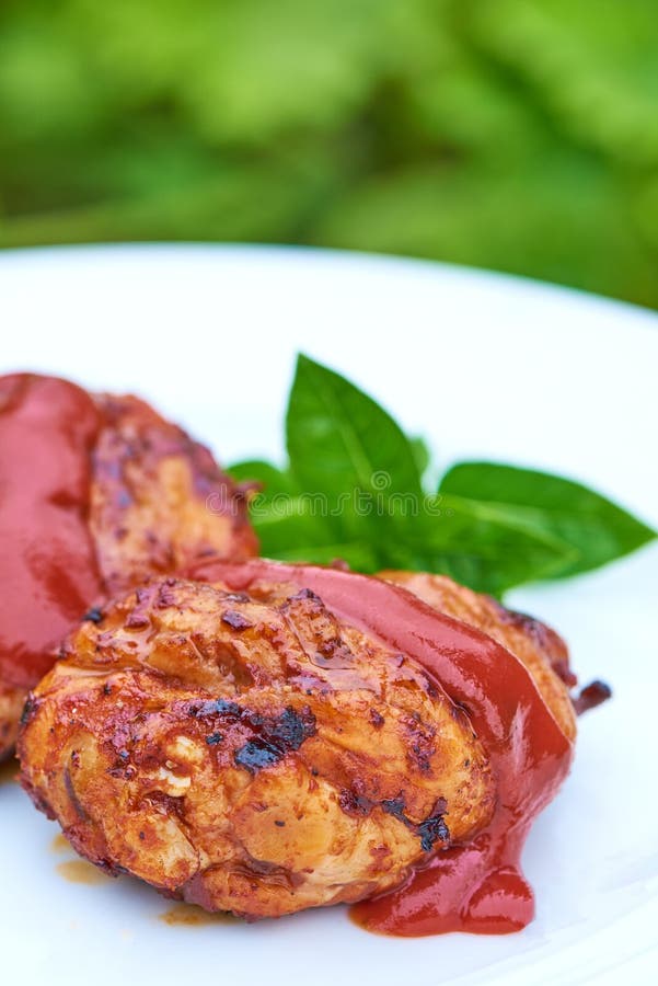 Grilled Chicken Legs with Tomato Sauce and Herbs on a Plate Stock Image ...