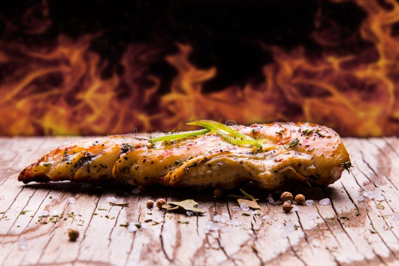 Grilled Chicken on a Old Wood Table with Background Fire Stock Photo ...