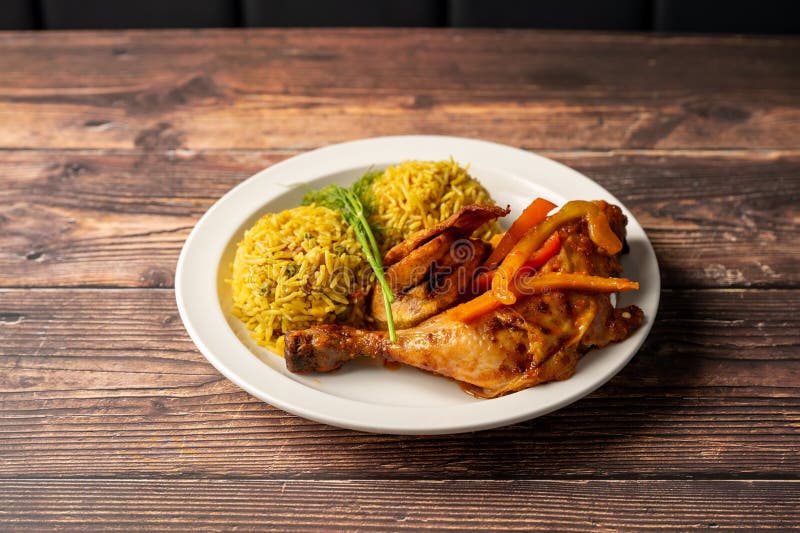 Grilled Chicken with Rice and Vegetables on a Wooden Table. Stock Photo ...