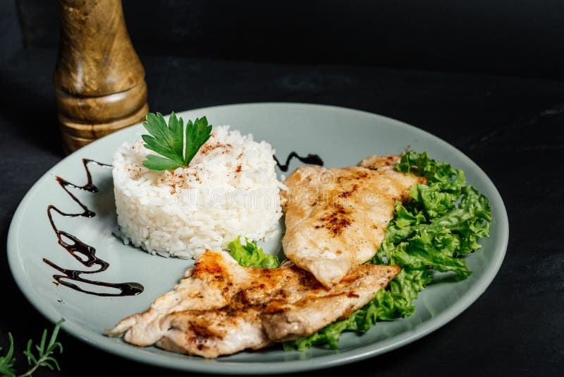 Grilled Chicken with Risotto and Parsley Served at Bistro Stock Photo ...