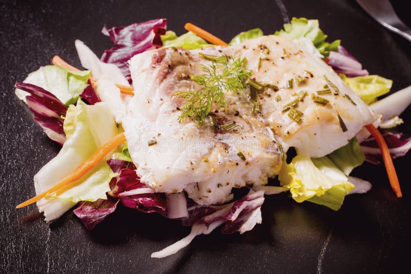 Grilled Cod Fillet with Salad on Black Slate Plate Stock Photo - Image ...