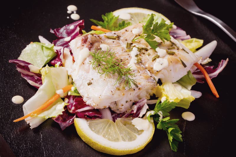 Grilled Cod Fillet with Salad on Black Slate Plate Stock Photo - Image ...