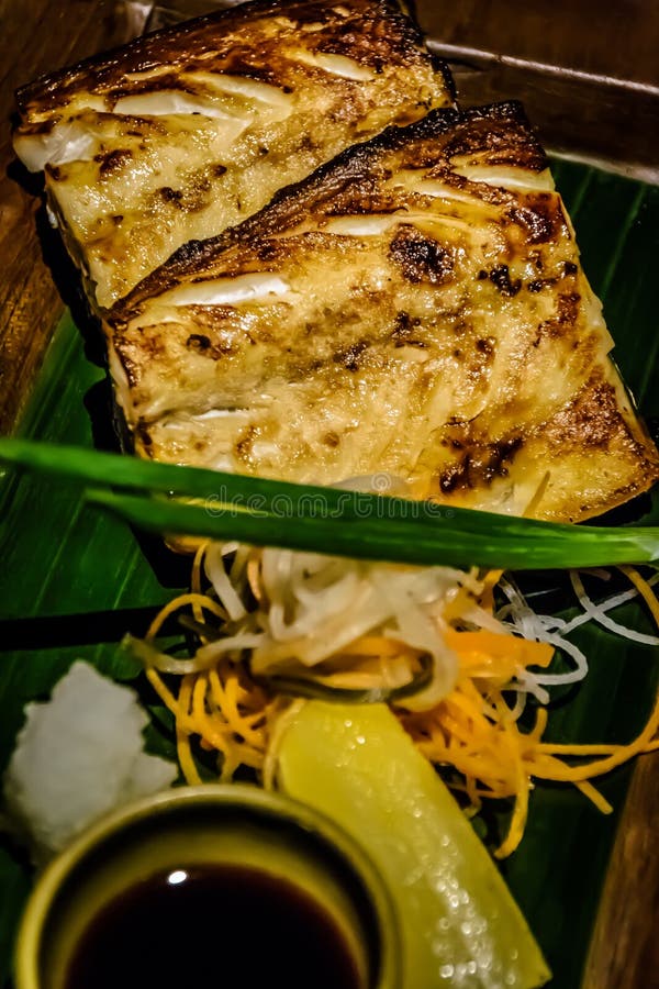 Grilled Cod Fish with a Wedge of Lemon and Soy Sauce on the Side Stock ...