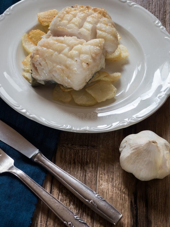 Grilled cod with potatoes stock photo. Image of plate - 141655310